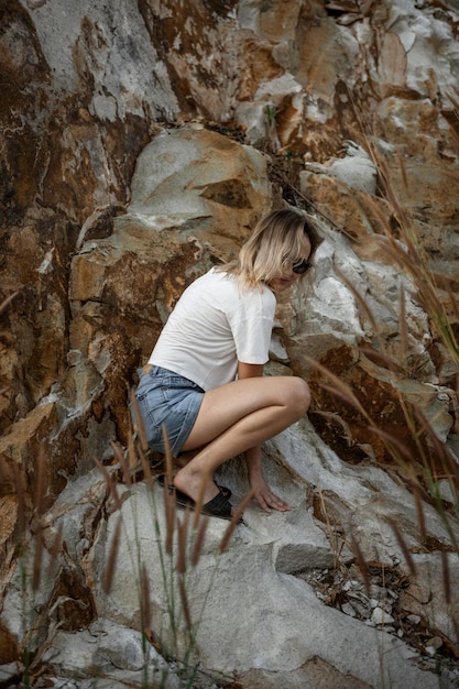 Premium Photo Side View Of Woman Crouching On Rock