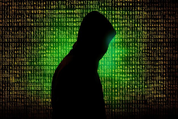 Premium AI Image | Silhouette of a faceless hooded anonymous computer hacker on a background of ...