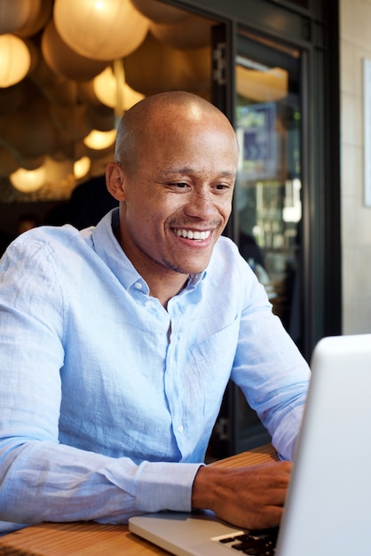 Premium Photo | Smiling african businessman working on laptop Premium Photo | Smiling african businessman working on laptop