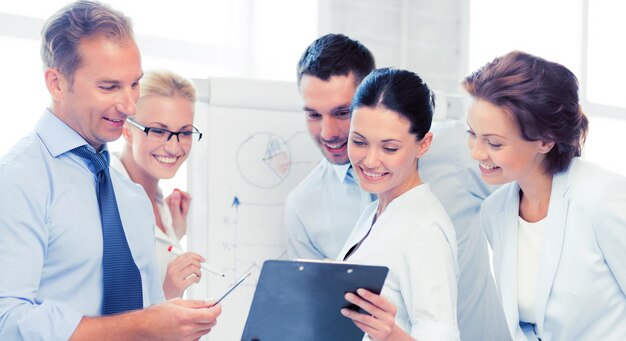 Premium Photo | Smiling business team discussing something in office Premium Photo | Smiling business team discussing something in office