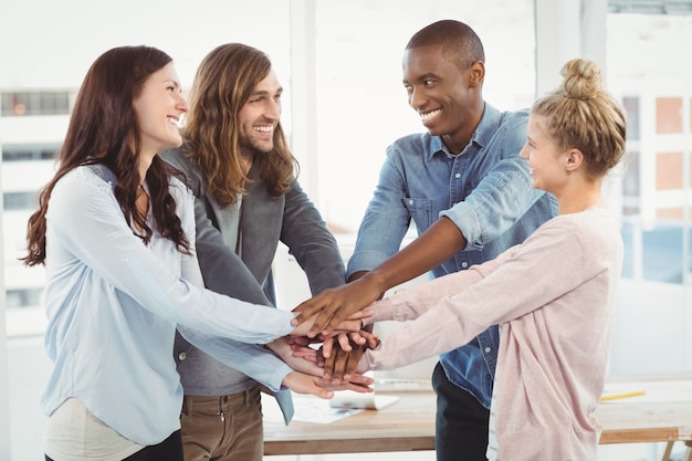 Premium Photo | Smiling business team putting their hands together Premium Photo | Smiling business team putting their hands together