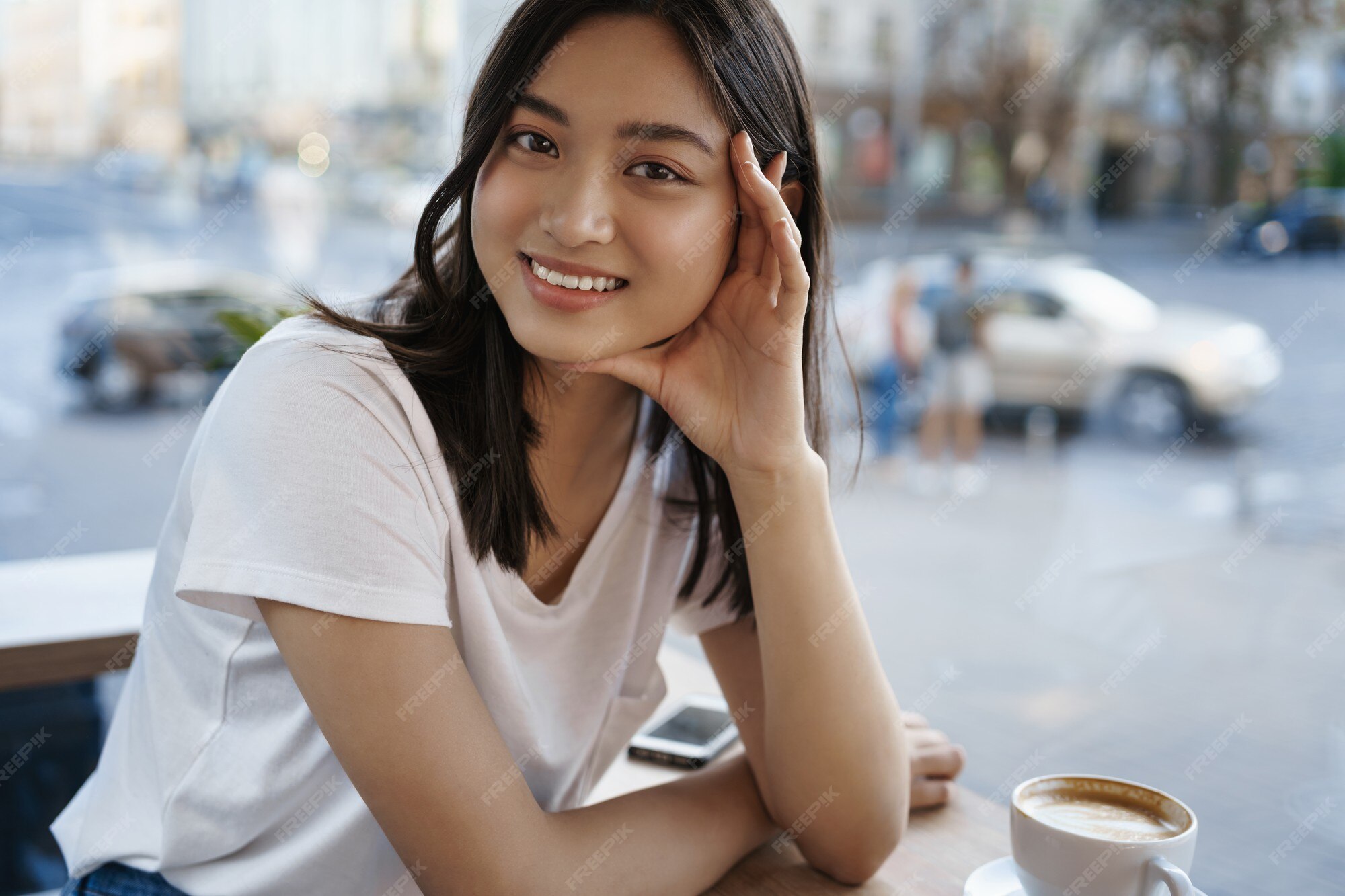 Premium Photo Smiling Candid Girl Sitting In Cafe Near Window Looking Happy At Camera While