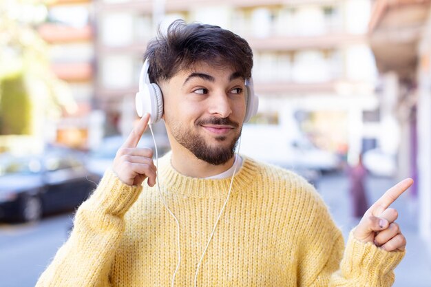 Premium Photo | Smiling cheerfully feeling happy and pointing to the side Premium Photo | Smiling cheerfully feeling happy and pointing to the side