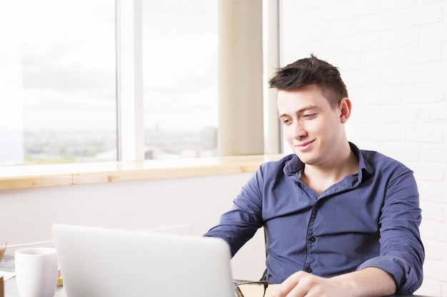 Premium Photo | Smiling man using laptop Premium Photo | Smiling man using laptop