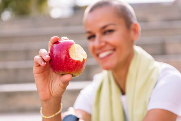 Premium Photo | Smiling sports woman showing a bitten apple Premium Photo | Smiling sports woman showing a bitten apple
