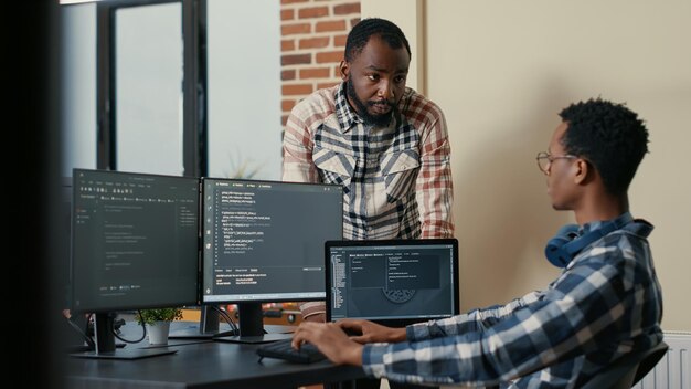 Premium Photo | Two programmers doing high five hand gesture at desk ...