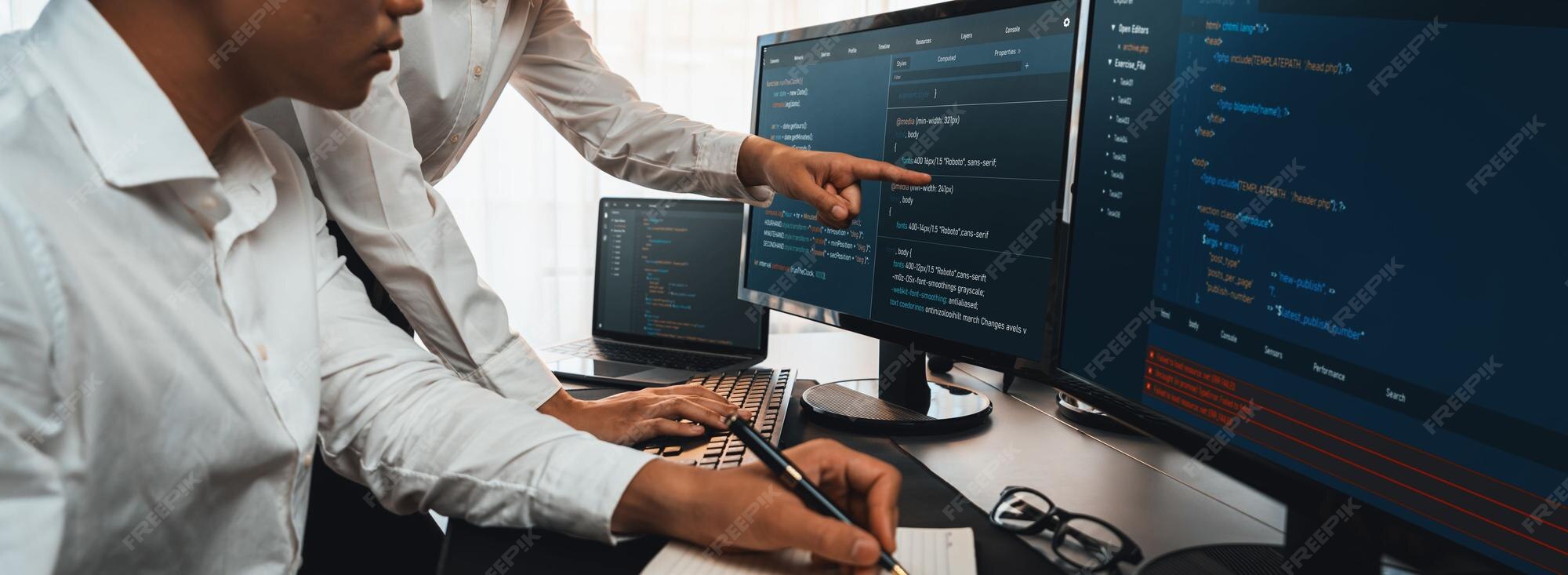 Premium Photo | Software development team working together in office coding script display on ...