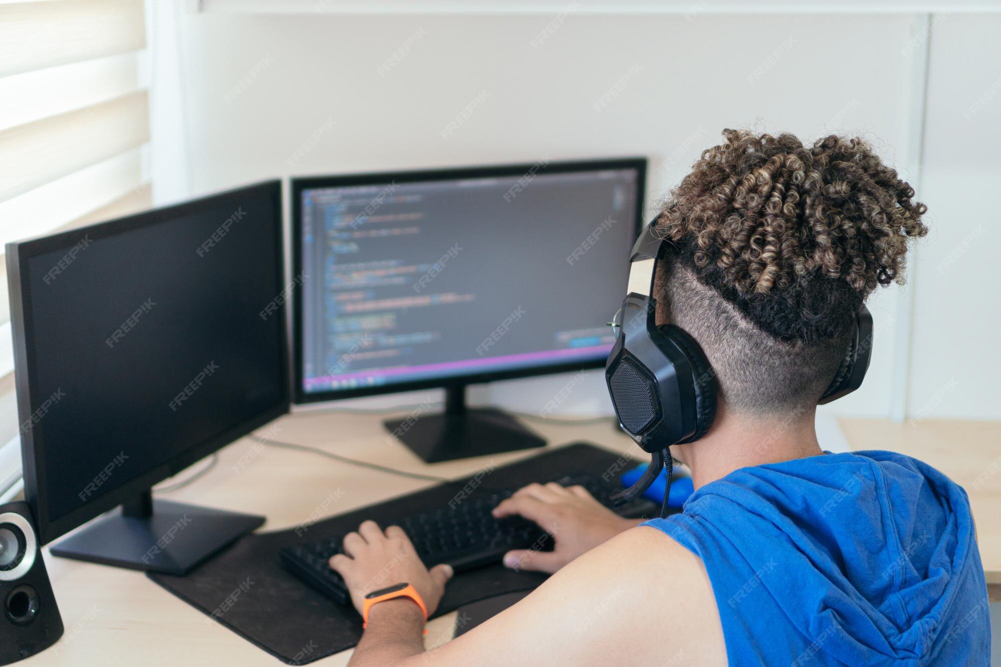 Premium Photo | Software engineer sitting at desk and typing on computer keyboard while creating ...