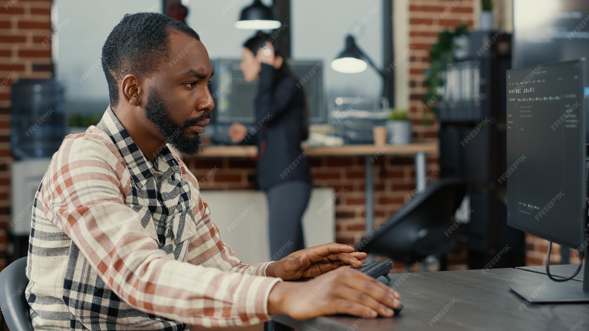 Premium Photo | Static portrait of african american system engineer working focused looking at ...
