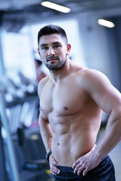 Premium Photo | Strong handsome man exercising at the gym Premium Photo | Strong handsome man exercising at the gym