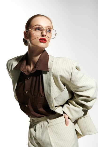 Premium Photo Stylish Woman In A White Suit And Glasses