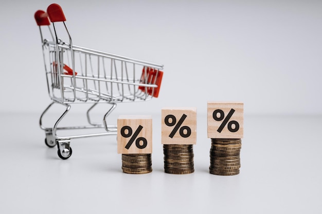 Premium Photo | Supermarket cart with percentage signs on wooden cubes Premium Photo | Supermarket cart with percentage signs on wooden cubes