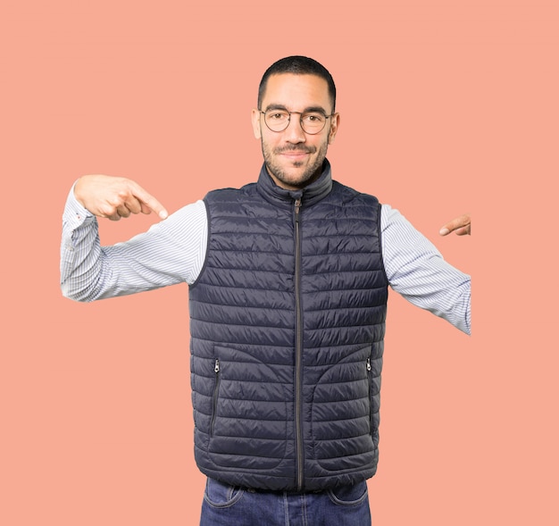 Premium Photo | Surprised young man pointing down Premium Photo | Surprised young man pointing down