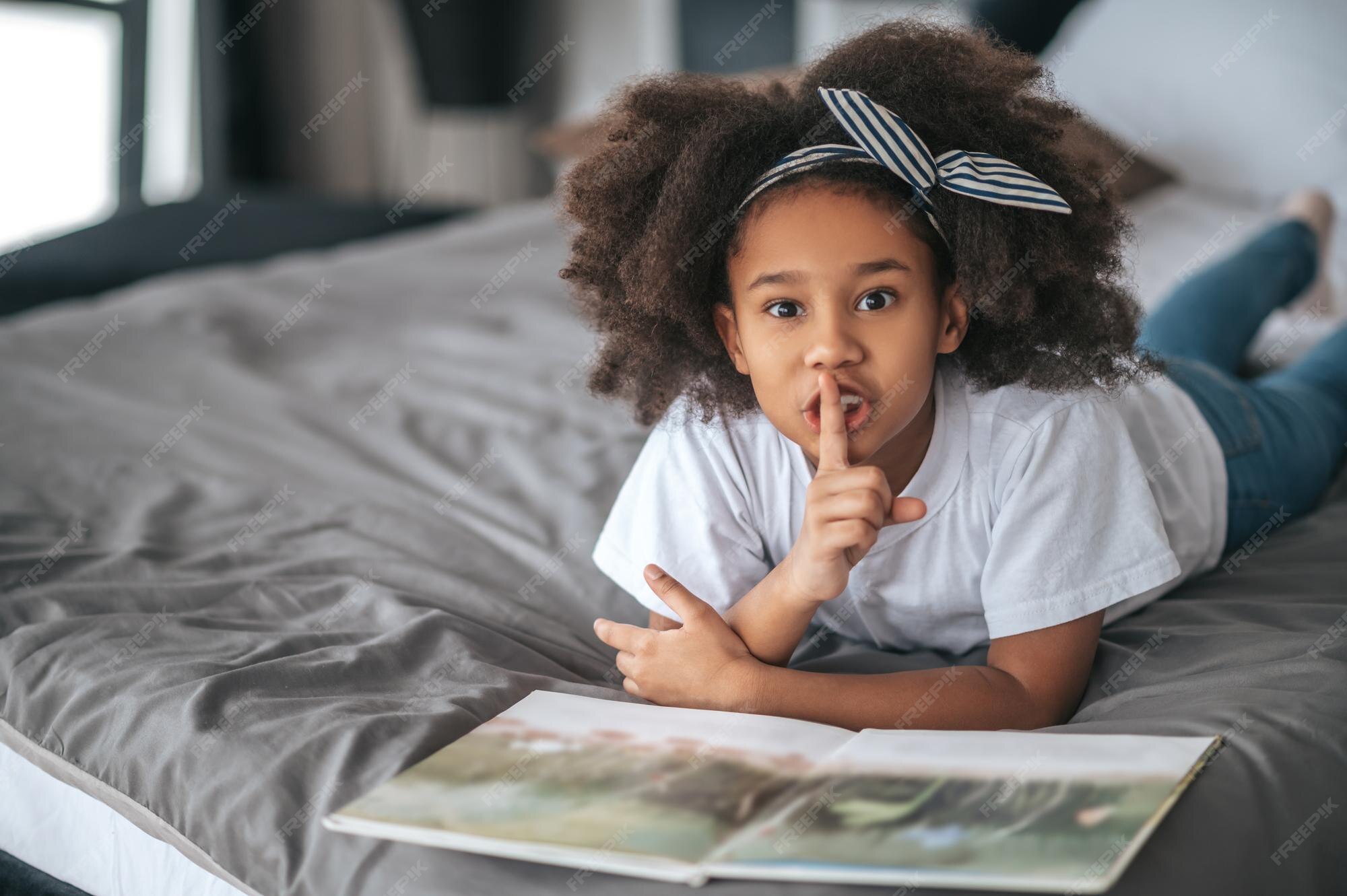 Premium Photo A Sweet Girl Showing Silence Sign And Looking Excited
