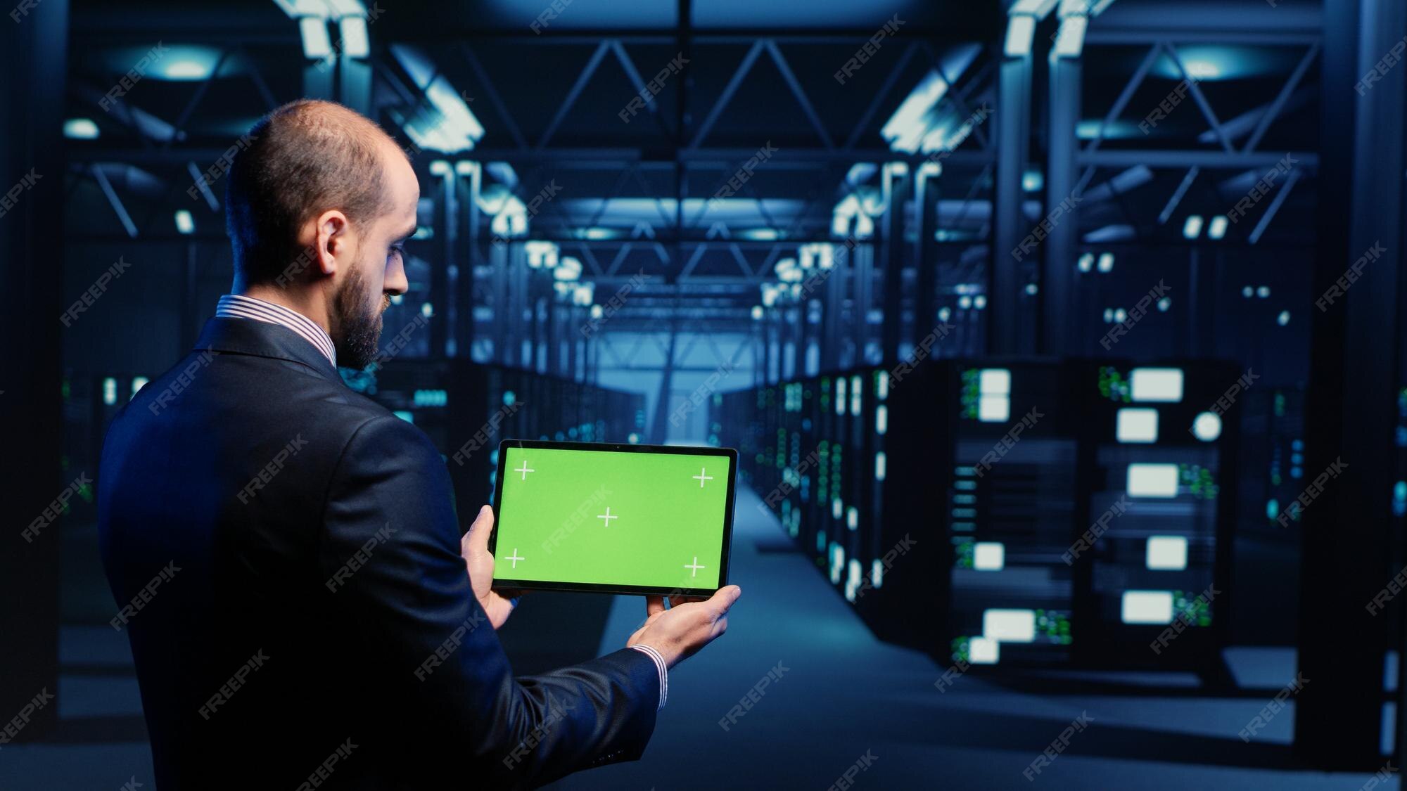 Premium Photo | System engineer checking green screen display on tablet, running mainframe ...