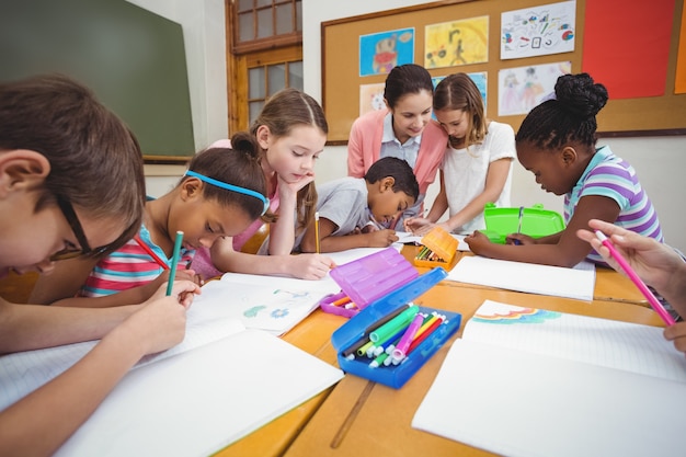 Premium Photo | Teacher and pupils working at desk together Premium Photo | Teacher and pupils working at desk together
