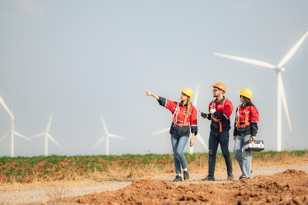 Premium Photo | Team of engineers working on wind turbines in a wind farm Premium Photo | Team of engineers working on wind turbines in a wind farm