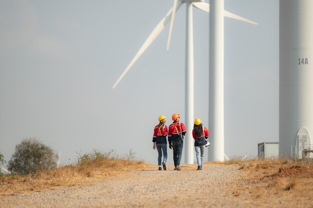Premium Photo | Team of engineers working on wind turbines in a wind farm Premium Photo | Team of engineers working on wind turbines in a wind farm