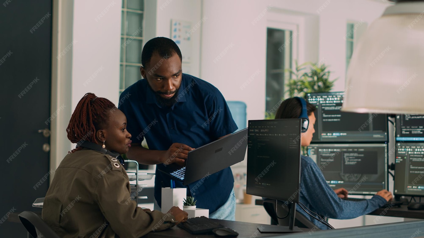 Premium Photo | Team of software developers talking about source code running on laptop to work ...