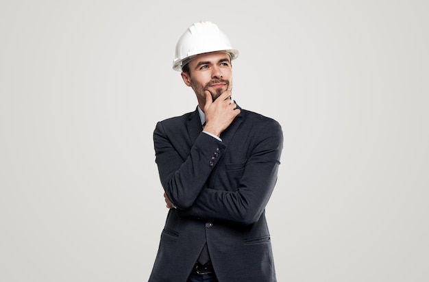 Premium Photo | Thoughtful male architect looking away Premium Photo | Thoughtful male architect looking away