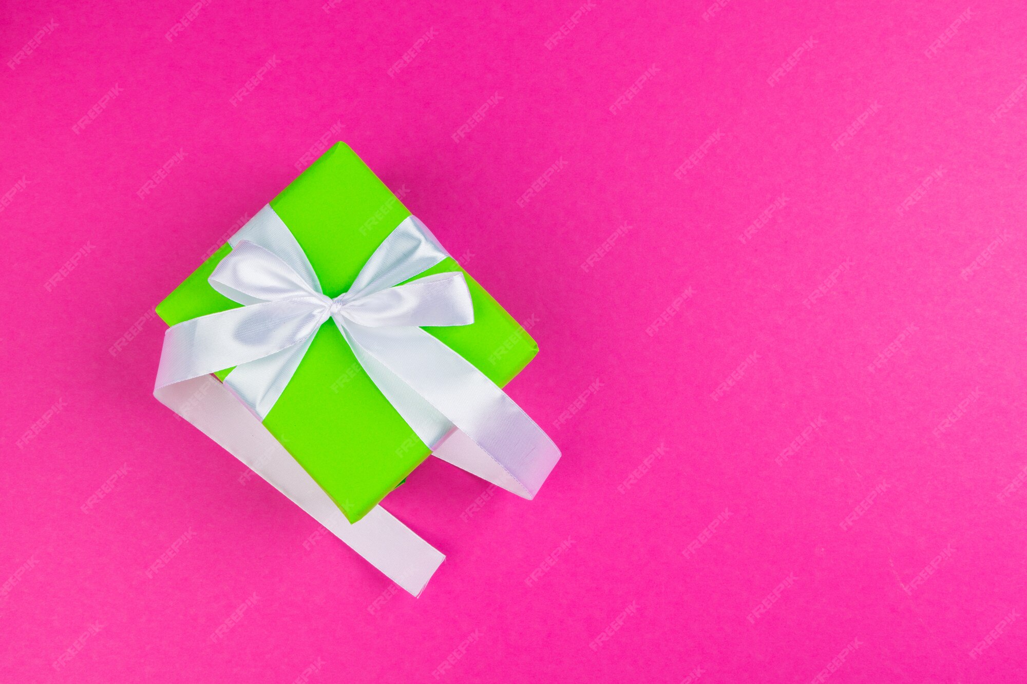 Premium Photo Top View Of A Decorated Present With A Bow On Pink