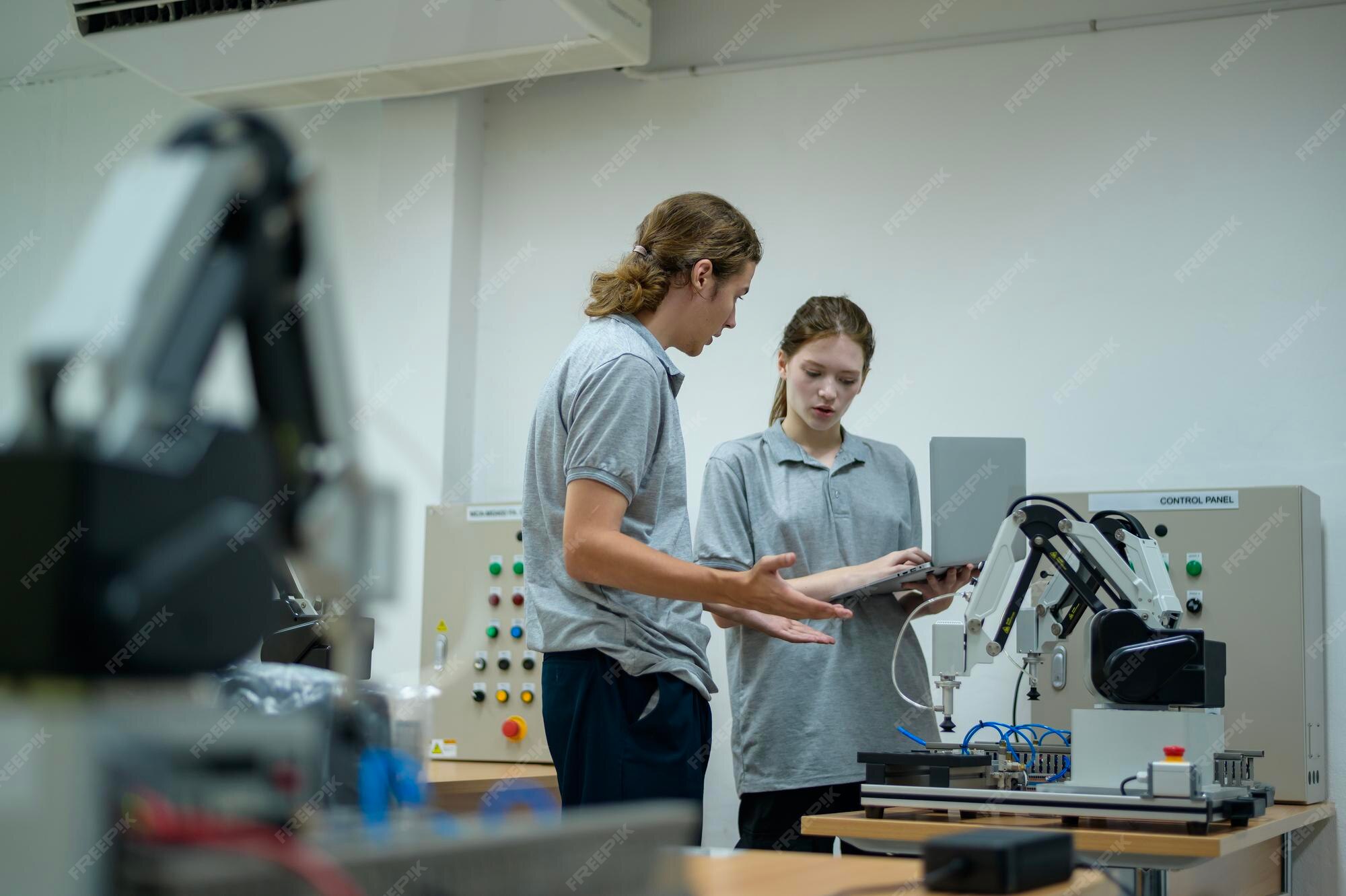 Premium Photo | Trainee Robotics engineer learning with Programming and ...