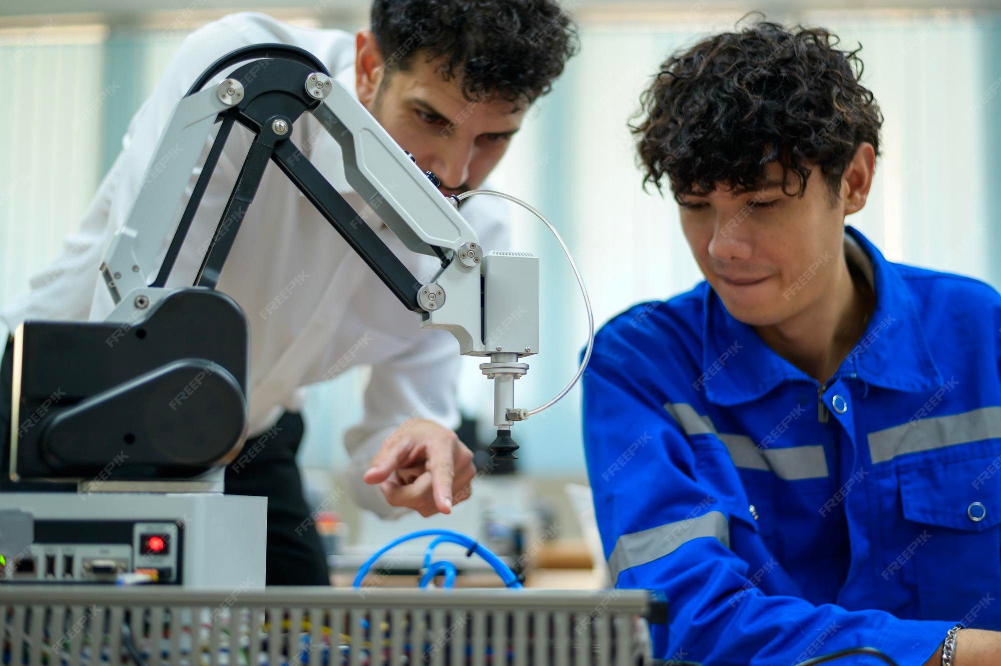 Premium Photo | Trainee Robotics engineer learning with Programming and ...