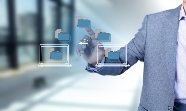 Premium Photo | Transferring files between laptops on a virtual screen Premium Photo | Transferring files between laptops on a virtual screen