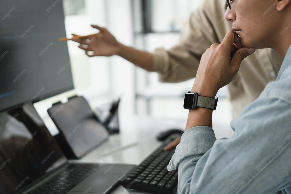 Premium Photo | Two developer programmer discussing to checking code on monitor about ...