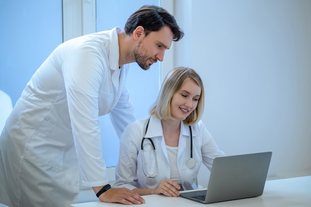 Premium Photo | Two people in lab coats discussing something and ... Premium Photo | Two people in lab coats discussing something and ...