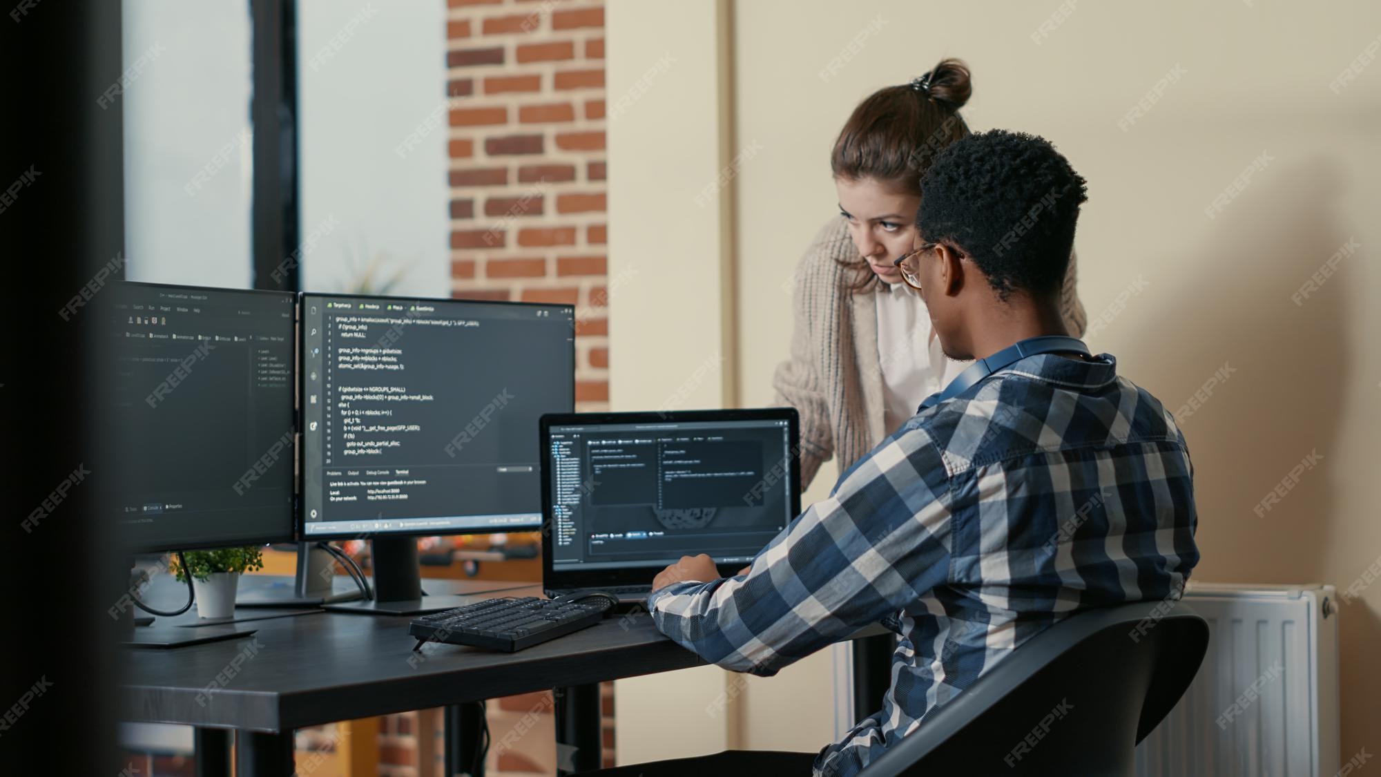 Premium Photo | Two programmers doing high five hand gesture at desk ...