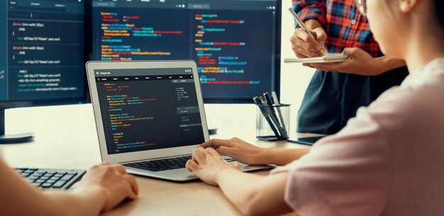 Premium Photo | Two smart cooperative computer engineers working together as teamwork to solve ...