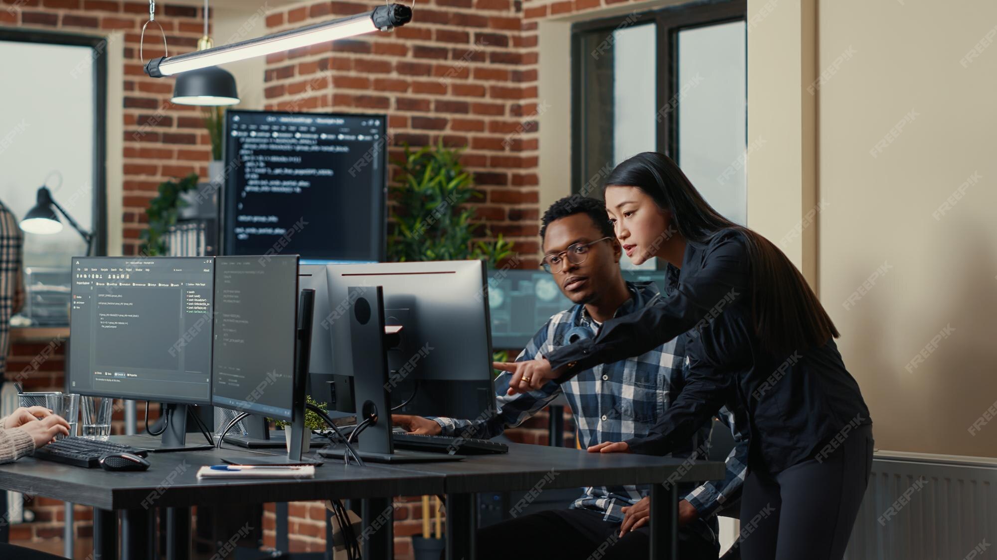 Premium Photo | Two software developers holding laptop with coding ...