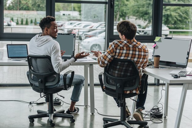 Premium Photo | Two young multicultural programmers discussing ideas ... Premium Photo | Two young multicultural programmers discussing ideas ...