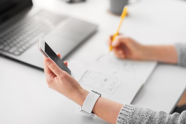 Premium Photo | Web designer working on smartphone user interface Premium Photo | Web designer working on smartphone user interface