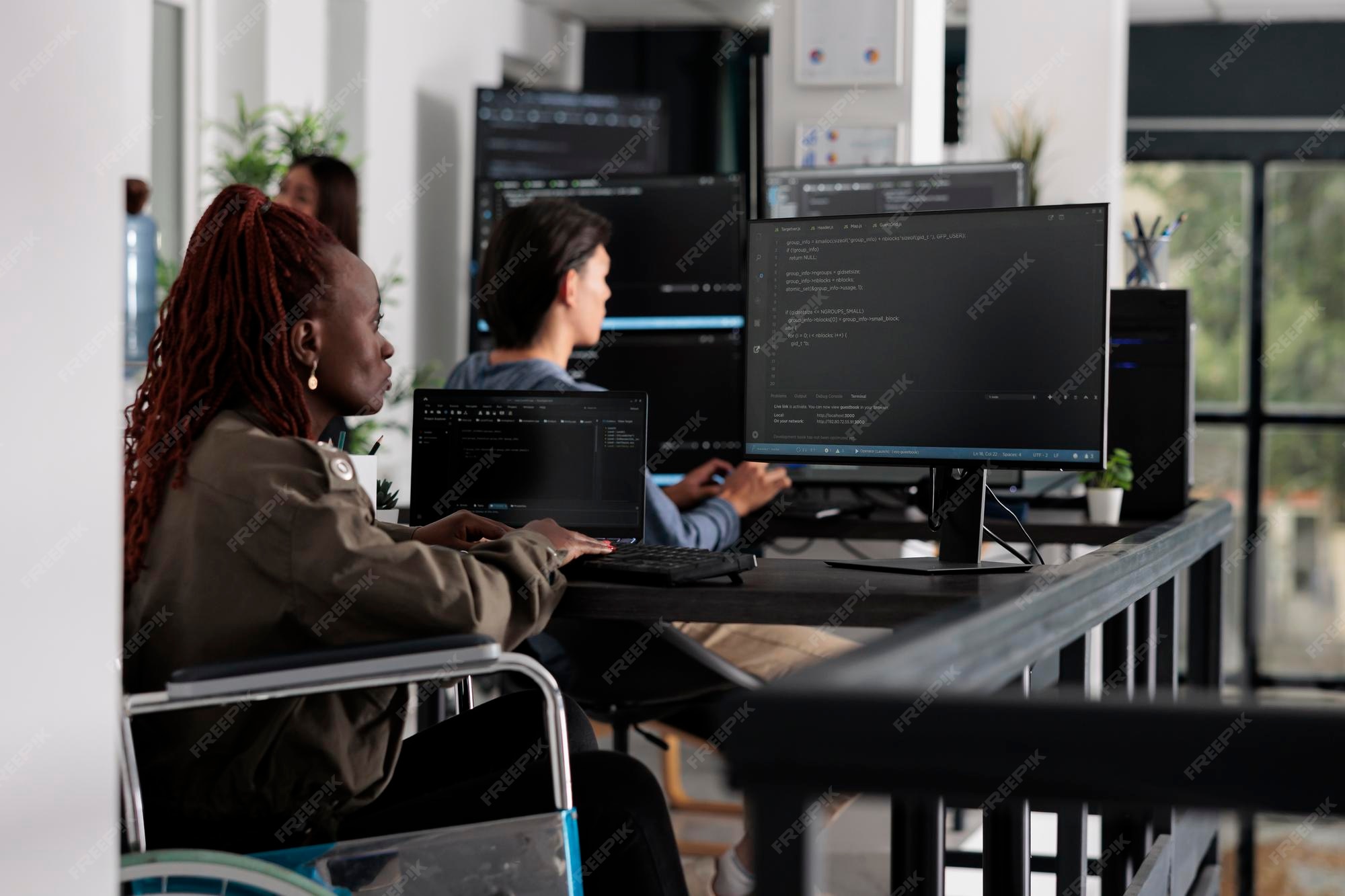 Premium Photo | Wheelchair user typing script code on computer, working with cloud computing ...