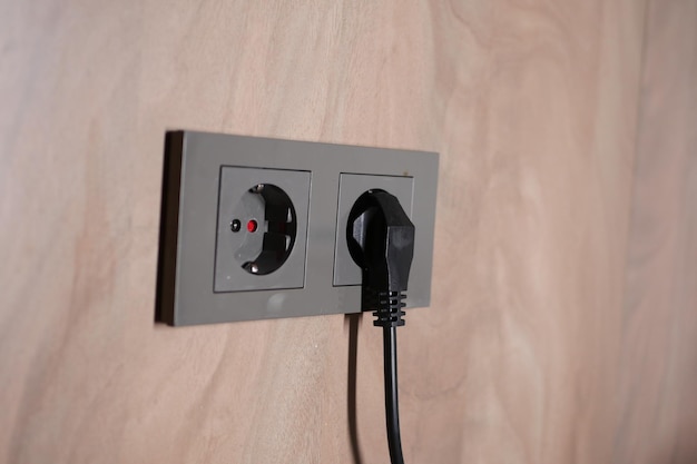Premium Photo | White color power cord cable plugged into wall Premium Photo | White color power cord cable plugged into wall