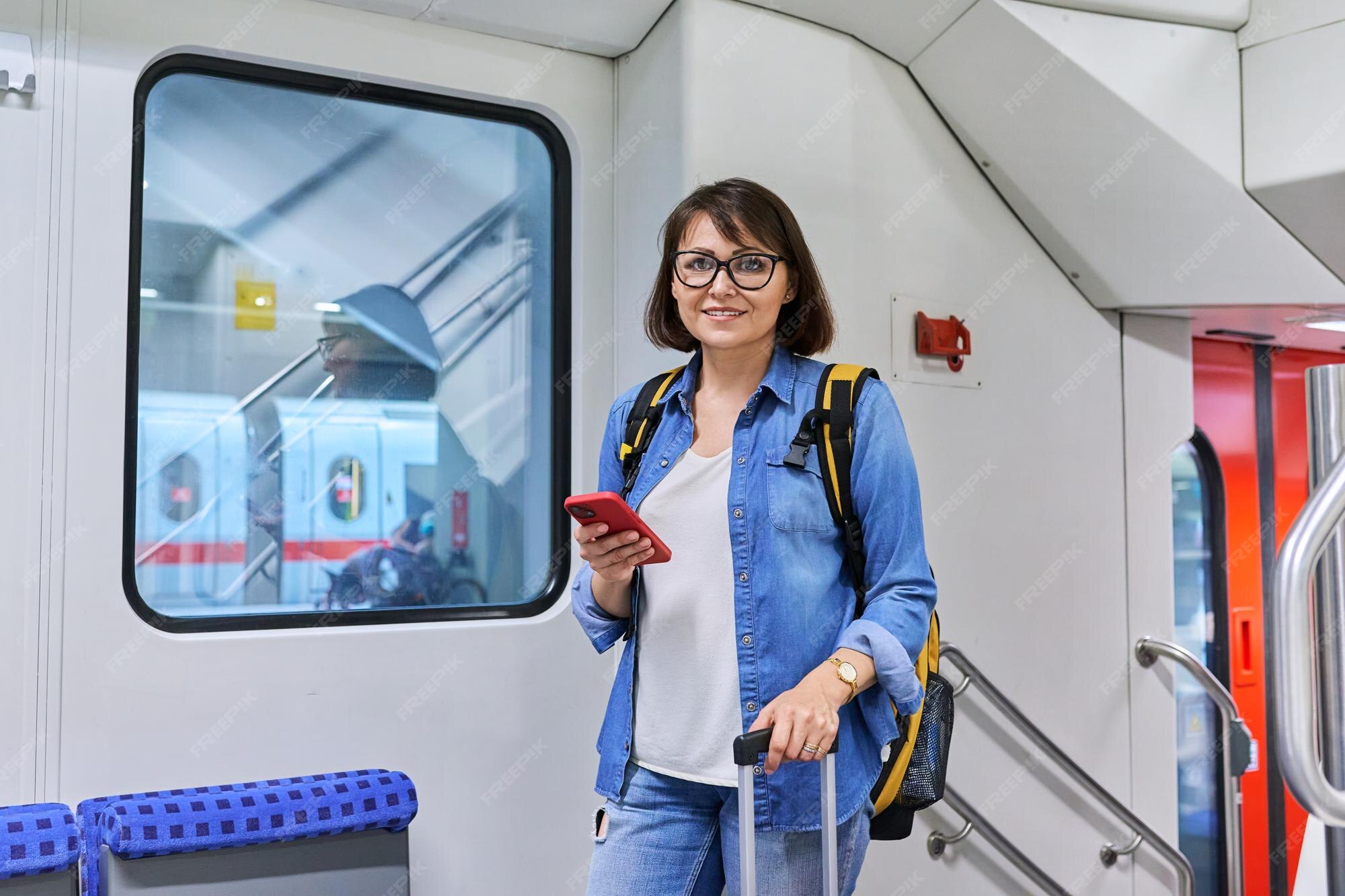 Premium Photo Woman Passenger With A Suitcase Backpack Standing Inside The Car Commuter Train
