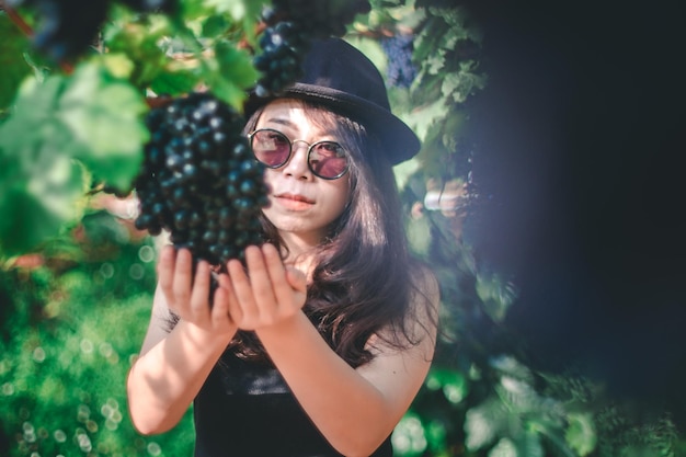 Premium Photo | Woman in sunglasses picking grapes Premium Photo | Woman in sunglasses picking grapes