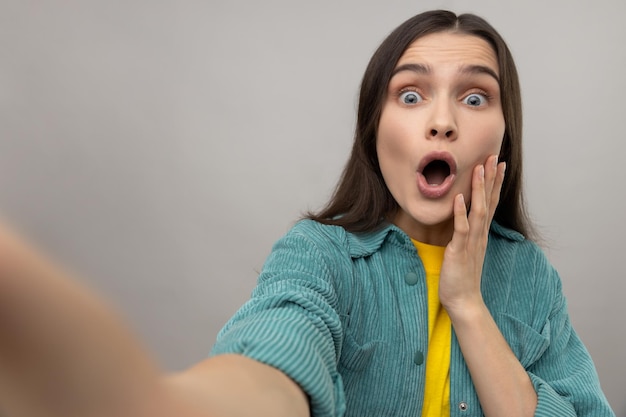 Premium Photo Woman Taking Selfie With Shocked Facial Expression Looking With Big Eyes And