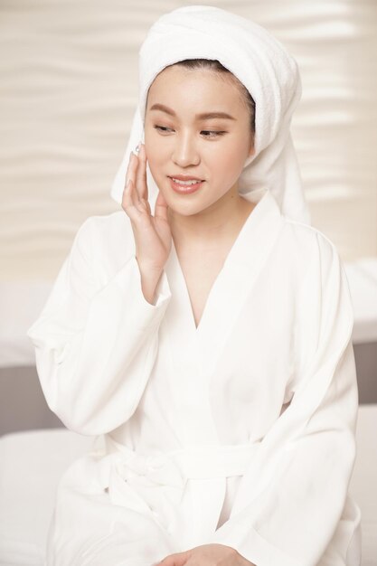 Premium Photo Woman Wearing Bathrobe Giving Facial Treatment