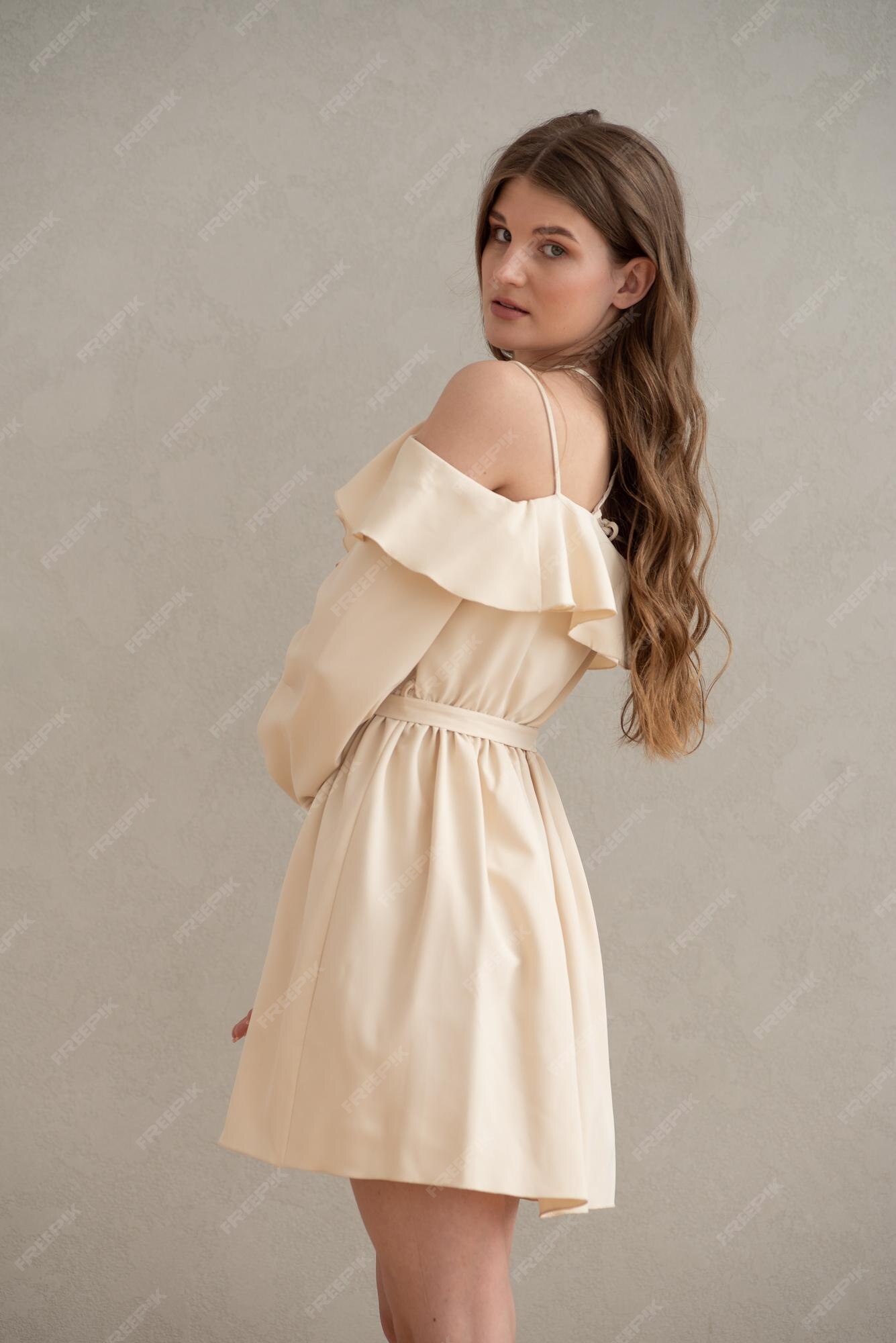 Premium Photo Woman Wearing A Beige Dress With A Ruffle Hem