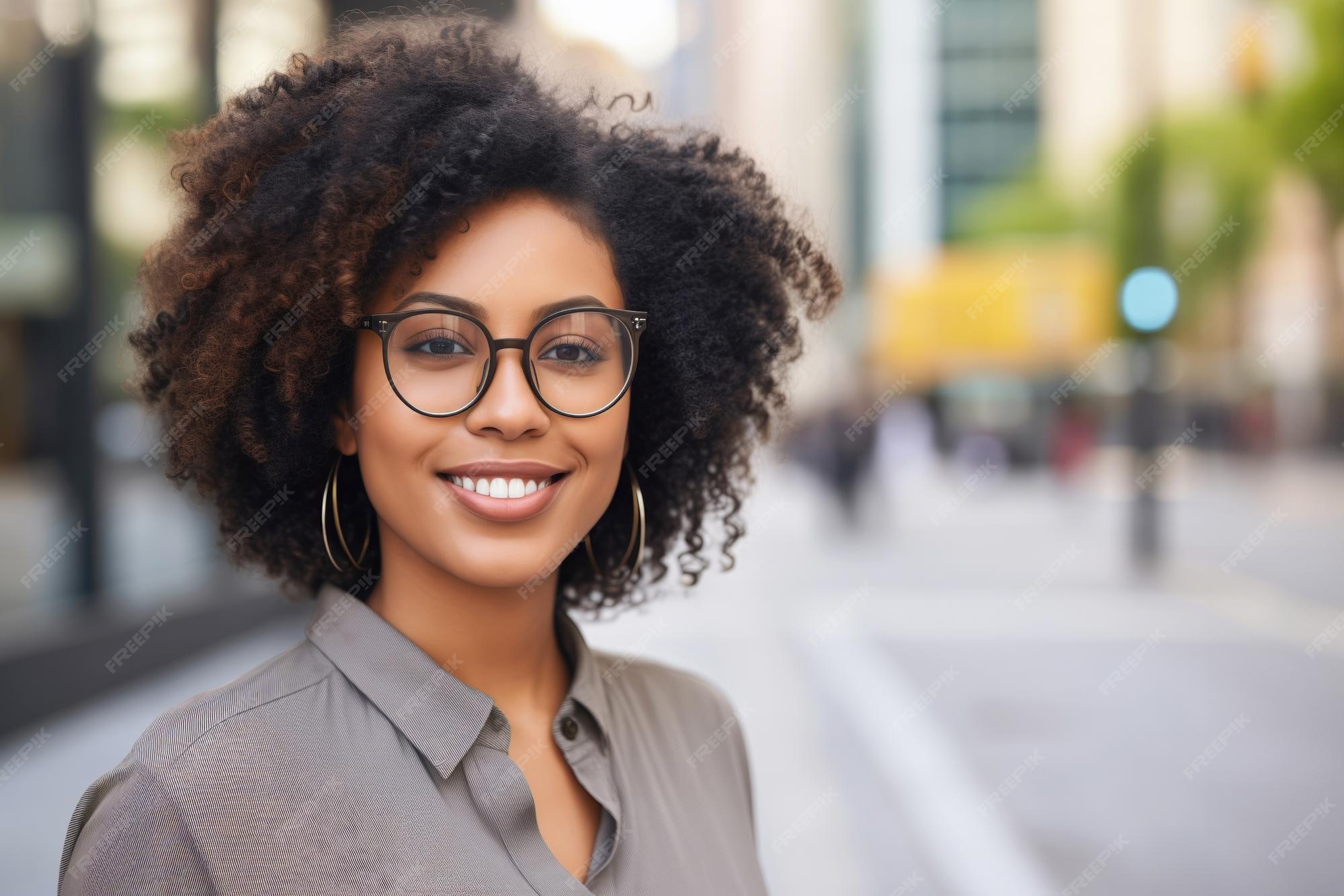 Premium Photo A Woman With Glasses And Curly Black Hair Smiling For The Camera