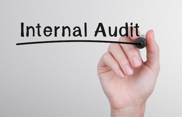 Premium Photo | Womans hand writing word internal audit with marker Premium Photo | Womans hand writing word internal audit with marker