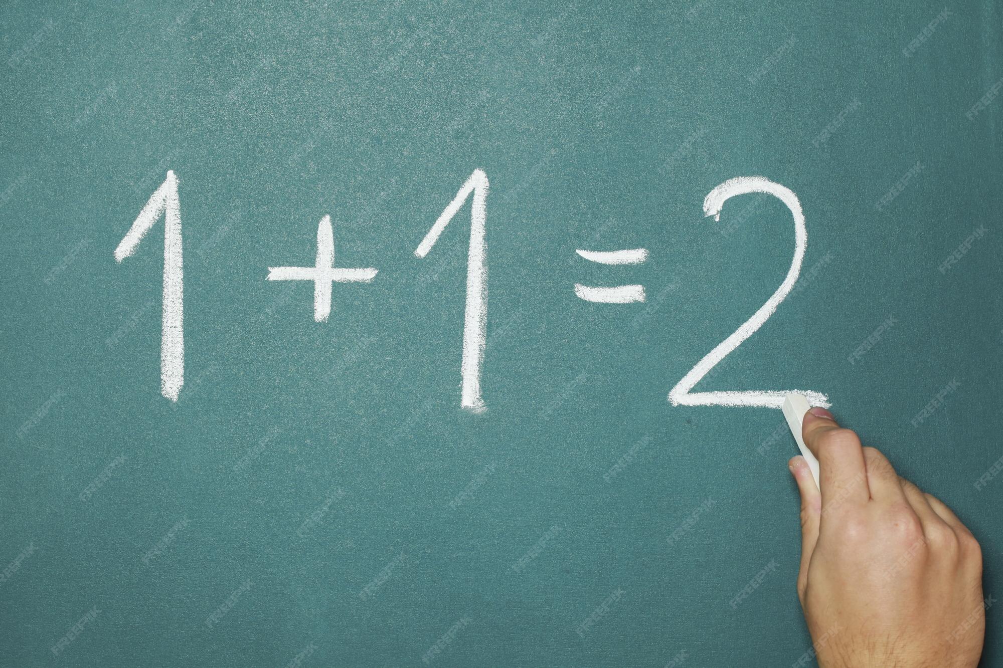 Premium Photo | Writing 1+1=2 equation on school board Premium Photo | Writing 1+1=2 equation on school board