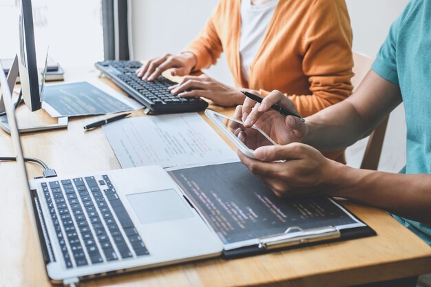 Premium Photo | Writing codes and typing data code technology, programmer cooperating working on ...