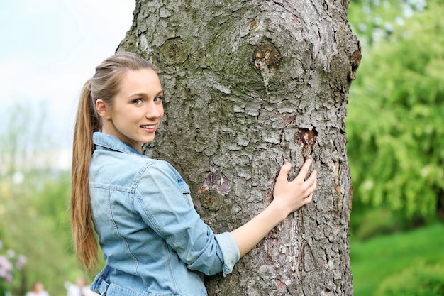 Premium Photo Young Beautiful Woman Hugging Tree Trunk