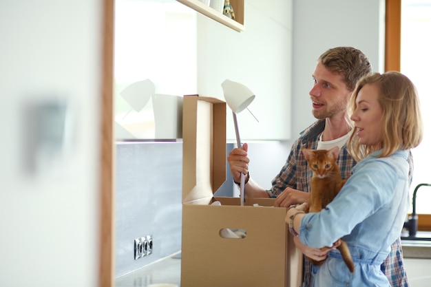 Premium Photo Young Couple Carrying Big Cardboard Box At New