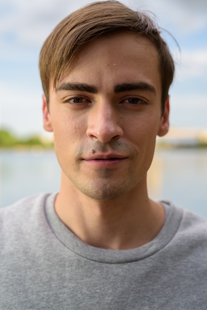 Premium Photo | Young handsome man relaxing at the park Premium Photo | Young handsome man relaxing at the park