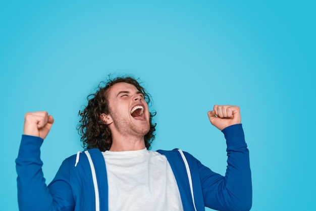 Premium Photo | Young man celebrating victory Premium Photo | Young man celebrating victory